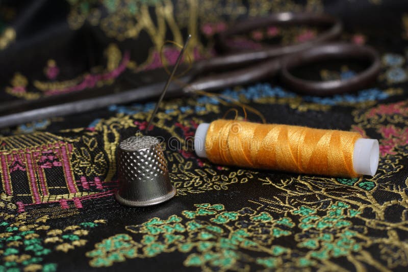 Yellow Thread and Thimble on Vintage Chinese Black Silk Stock Image ...