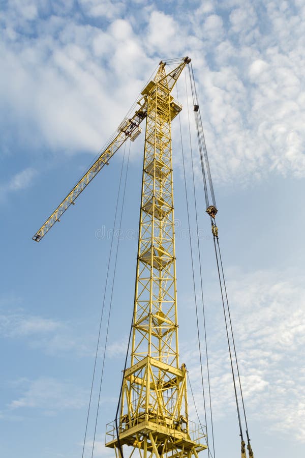Yellow Tower Crane on a Background of Blue Sky with Clouds, Industry ...