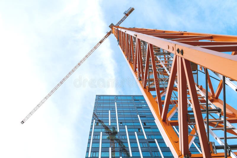 Yellow Tower Crane. Bottom View of a Tall Construction Crane Next To a ...