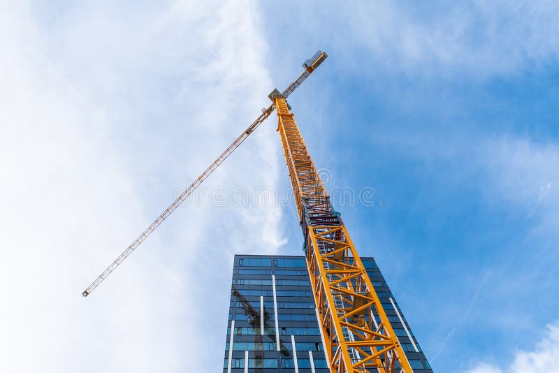 Yellow Tower Crane. Bottom View of a Tall Construction Crane Next To a ...