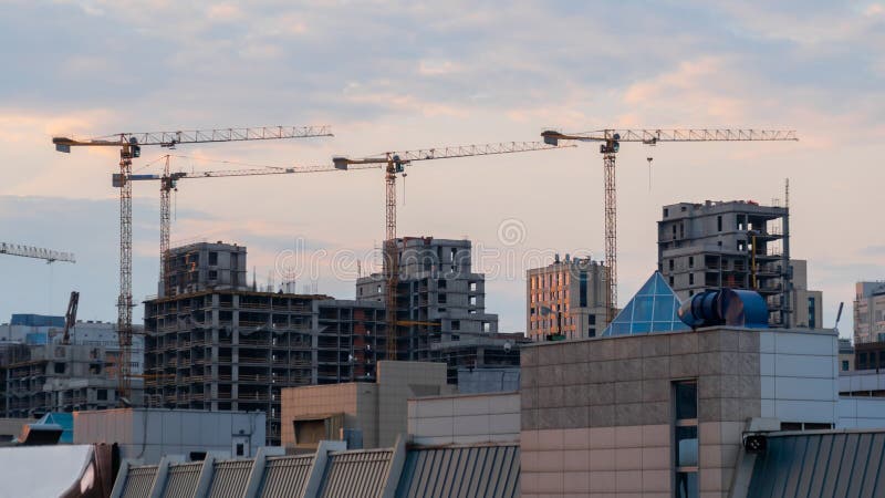 Yellow Tower Cranes and Unfinished Building Construction Against ...