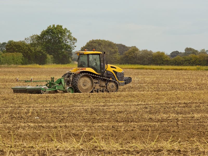 Yellow tractor stock image. Image of blue, yellow, farming - 10607549