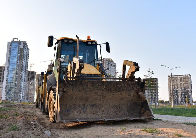 Yellow Tractor with Bucket at Construction Site Stock Photo - Image of ...