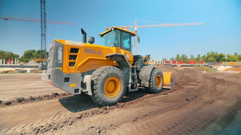 Yellow Tractor on a Construction Site. Work Process at a Construction ...