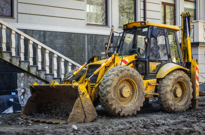 Yellow Tractor On Construction Site Stock Photo - Image of blue, heavy ...