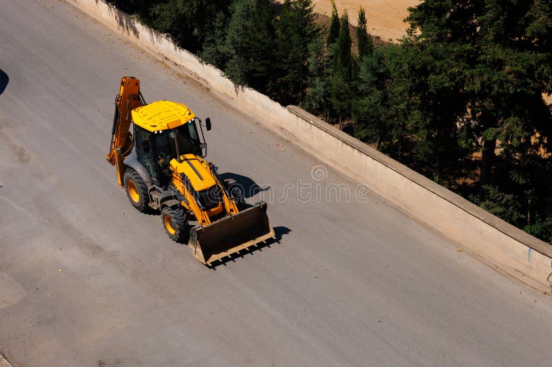 An Yellow Tractor Goes on the Road Stock Photo - Image of dozer ...