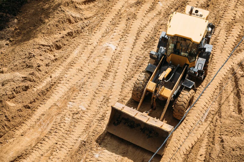 Yellow Tractor in the Sand Top View Stock Photo - Image of capacity ...