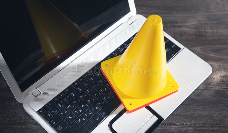 Yellow Traffic Cone on Laptop Keyboard Stock Image - Image of laptop ...