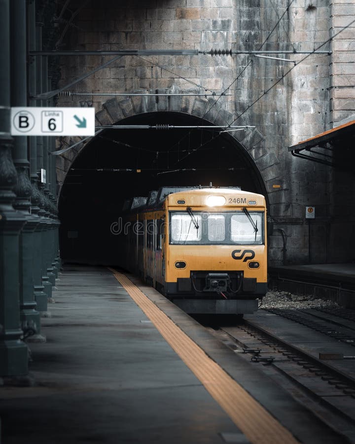 Yellow Train Emerging from a Tunnel at a Train Station Platform. Stock ...