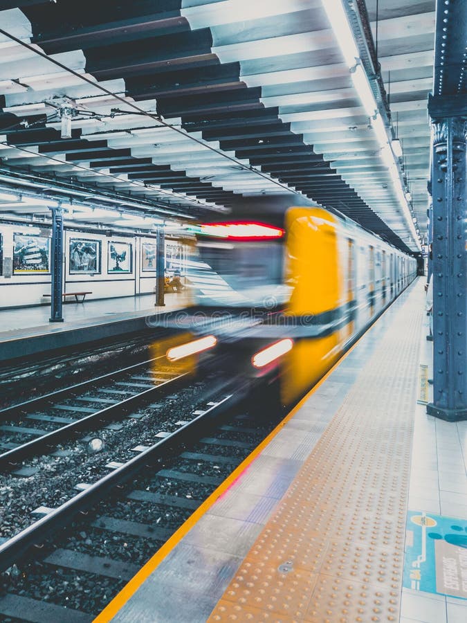 Yellow Train in Motion in Railway Station Platform Stock Image - Image ...