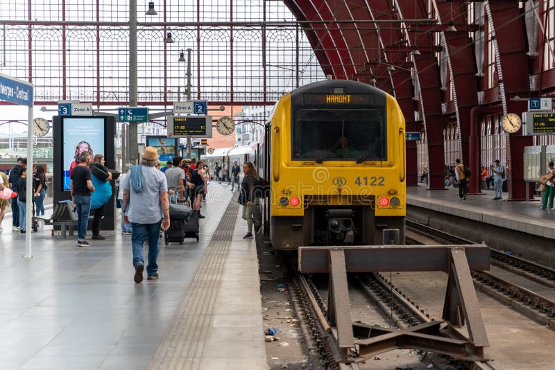 Yellow Train with People on the Platform of Antwerpen-Centraal Railway ...