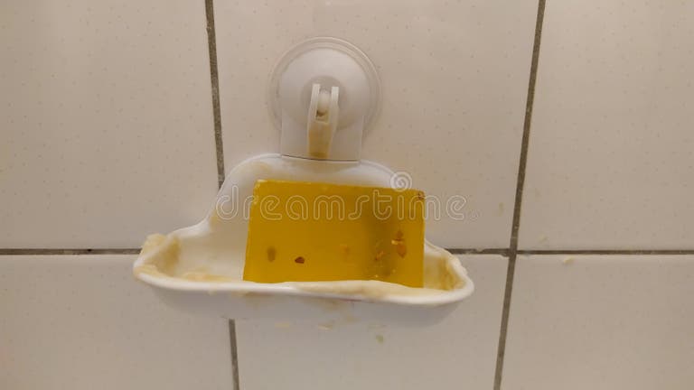 Yellow Soap in a White Soap Dish Hanging on the Tiled Wall in the ...
