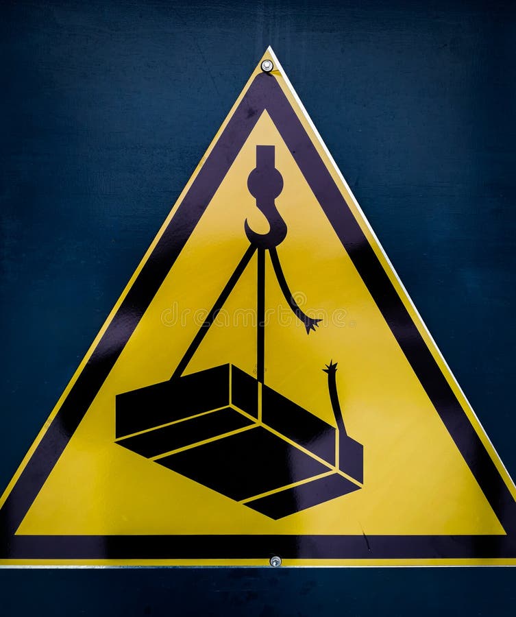 Yellow Triangle Warning Sign on a Blue Background with a Crane and a ...