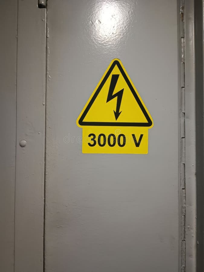 A Yellow Triangular Sign Warning of High Voltage (3000V) with a ...