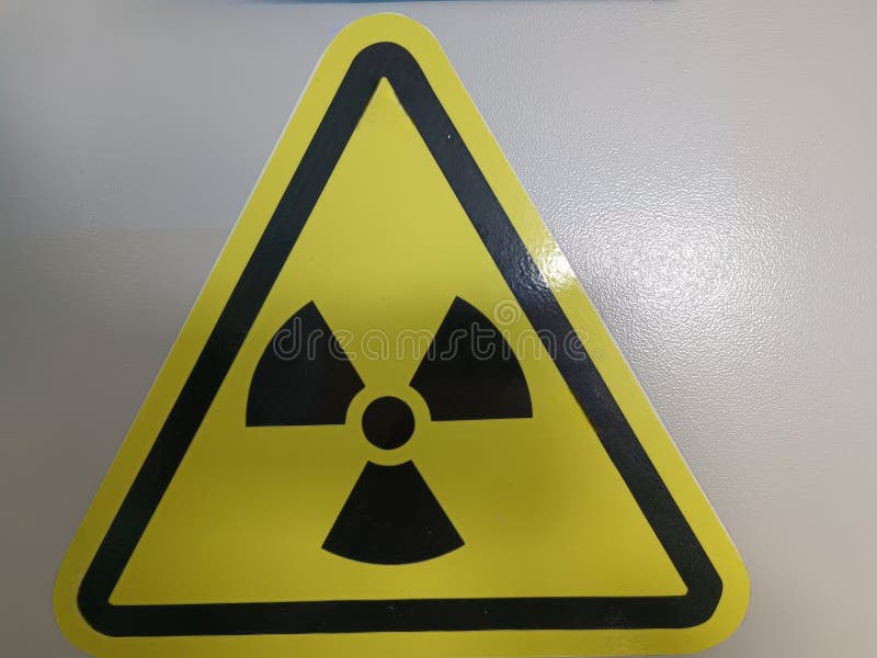 A Yellow Triangular Warning Sign with a Black Radiation Symbol ...