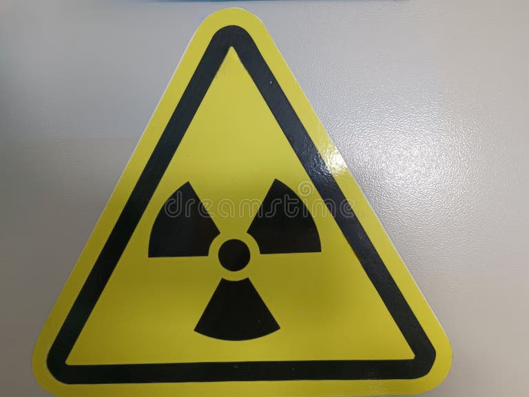 A Yellow Triangular Warning Sign with a Black Radiation Symbol ...