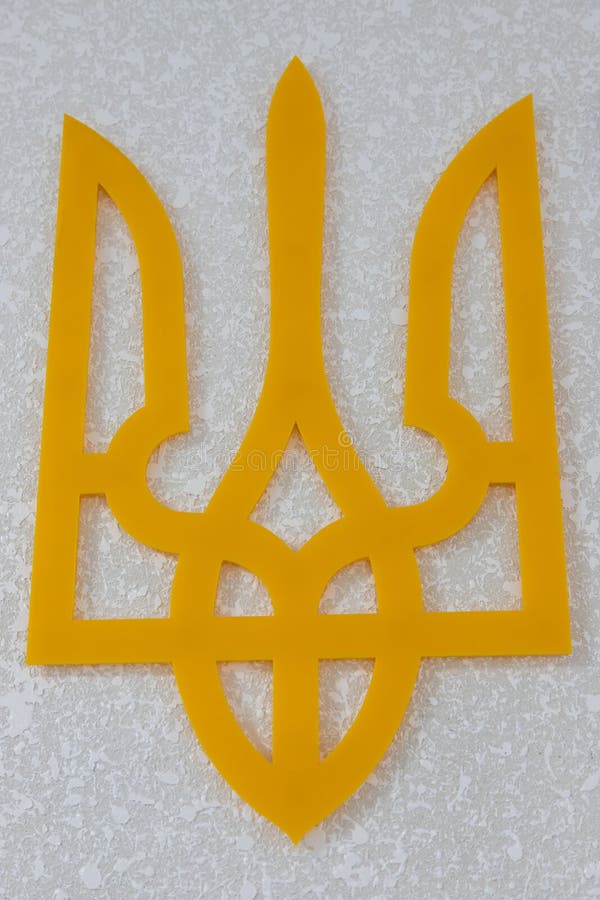 Yellow Trident Emblem Displayed on a Light Textured Surface ...