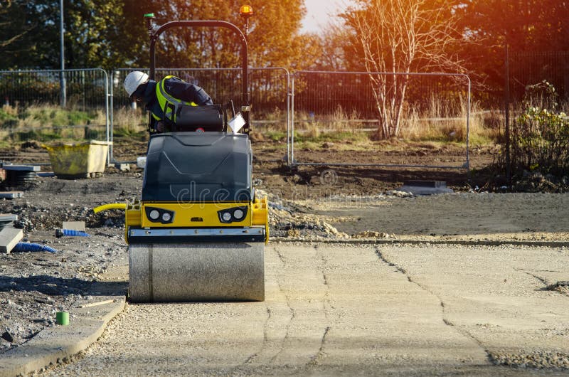 Yellow Vibration Road Roller Compacting Ground and Stone on ...