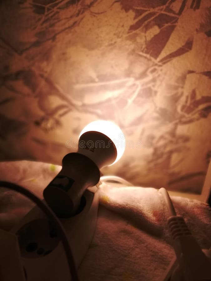 Yellow Warm Light of a Home Lamp at Dusk, Round Device with a Switch ...