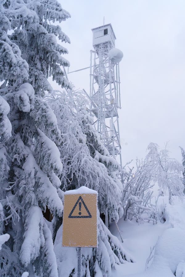 Yellow Warning Sign in Front of a Frozen Watchtower Stock Image - Image ...