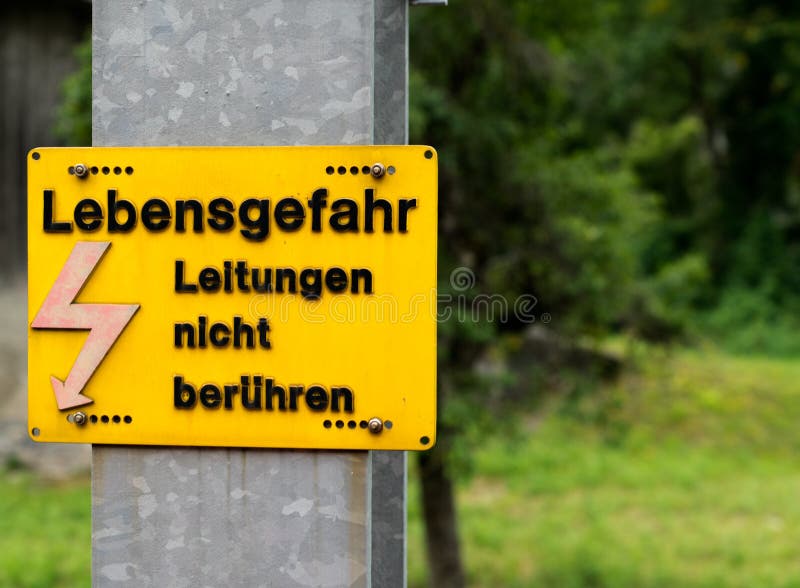 Yellow Warning Sign with German Text Reading Stock Photo - Image of ...