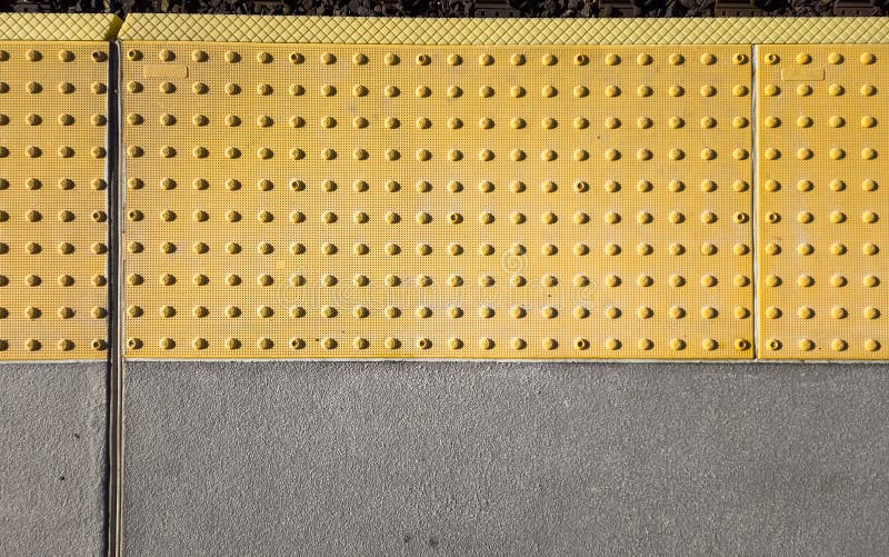 Yellow Warning Tile Bumps in Front of Train Tracks Stock Image - Image ...