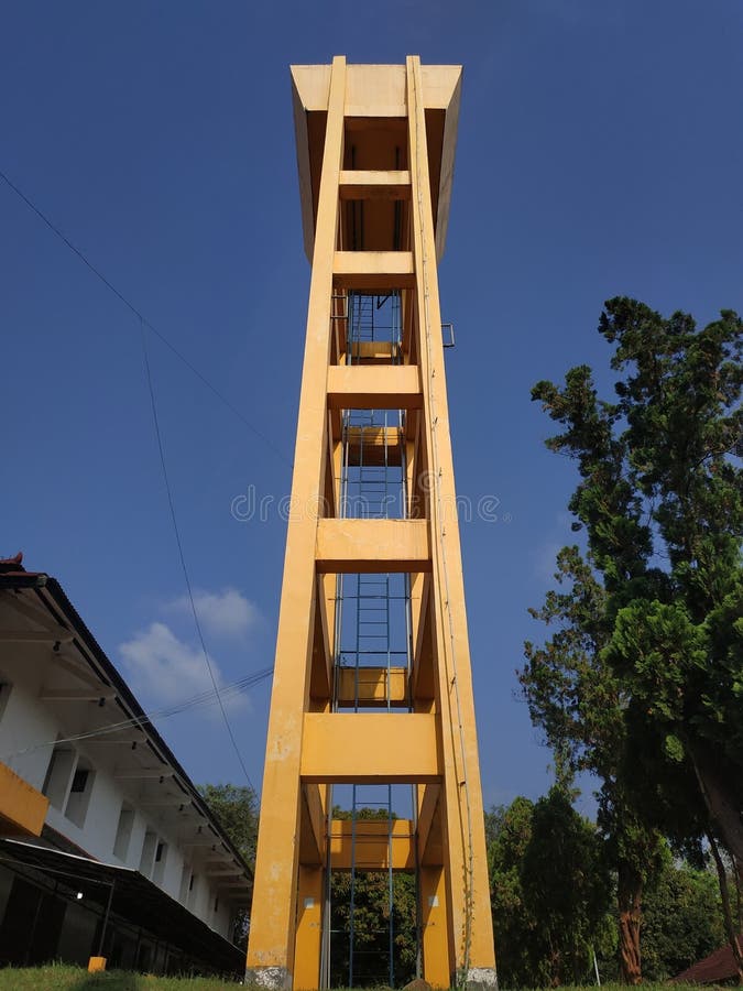 Yellow Water Tower stock photo. Image of clouds, building - 274451572