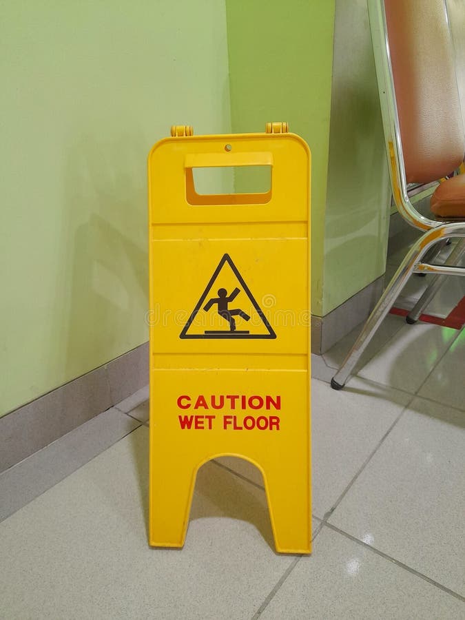 Yellow Wet Floor Sign in a Corner, Cautioning Against Slips Stock ...