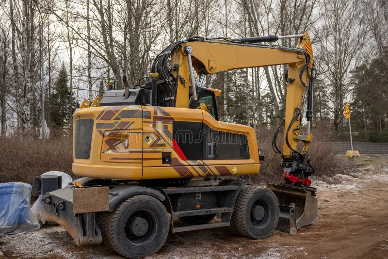 Yellow Wheeled Excavator with Geometric Patterns at Construction Site ...