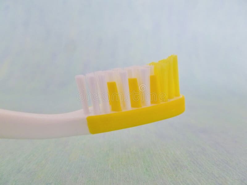 A Yellow White Toothbrush on Blue Texture Background. Close Up Details ...