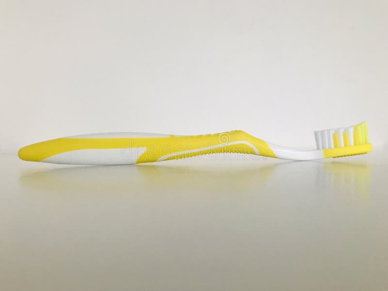 A Yellow and White Toothbrush on White Marble Texture Background. Stock ...