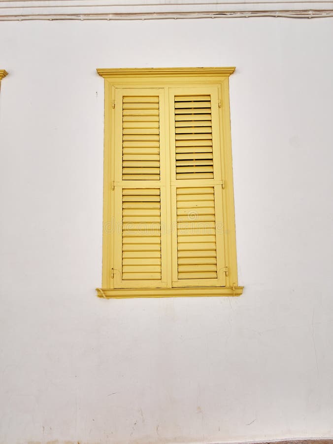 Yellow Window Shutters on White Wall Stock Image - Image of paint ...