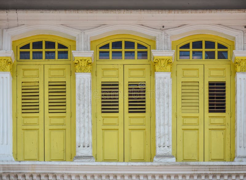 Yellow Windows with Shutters on White Wall Stock Image - Image of ...