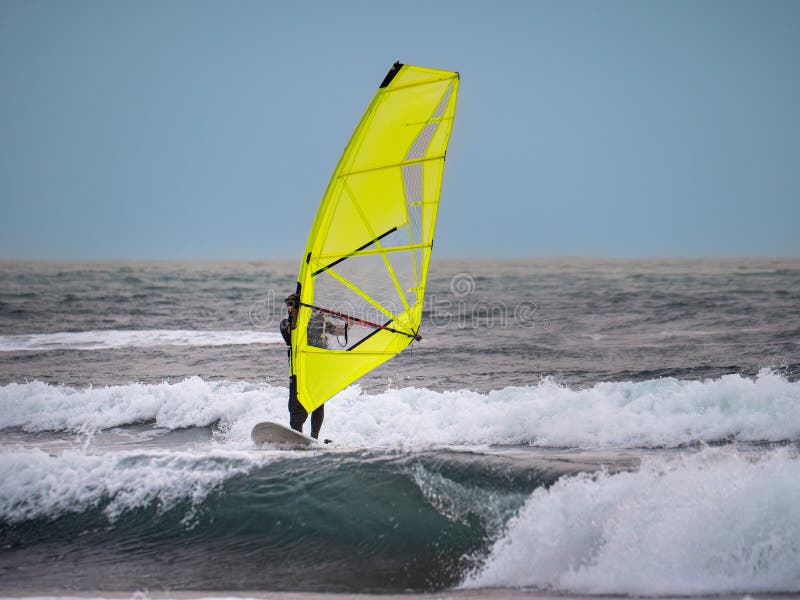 Yellow Windsurf Riding the Waves Stock Photo - Image of rough, speed ...