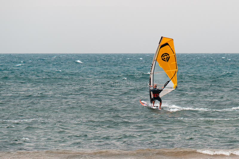 Yellow Windsurf Riding the Waves in a Choppy Sea Stock Image - Image of ...