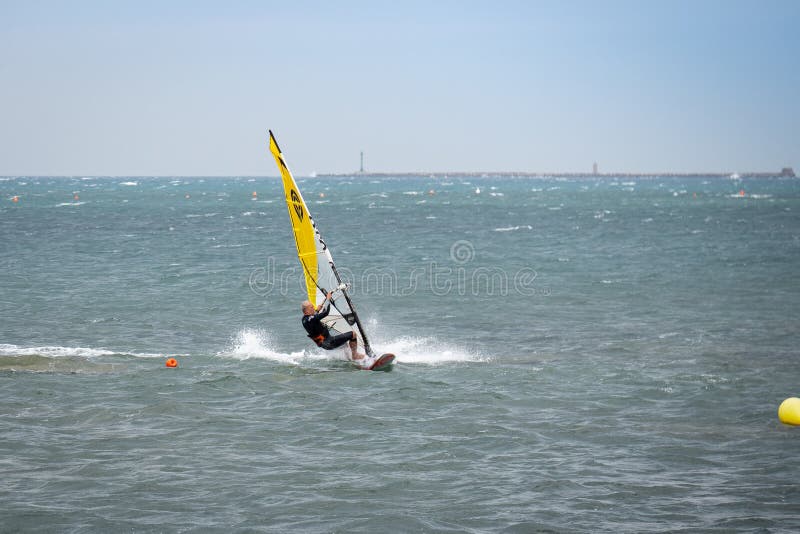 Yellow Windsurf Riding the Waves in a Choppy Sea Editorial Photography ...