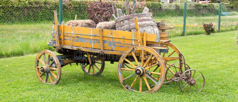 Yellow Wooden Wagon with Painted Wheels. Stock Photo - Image of ...