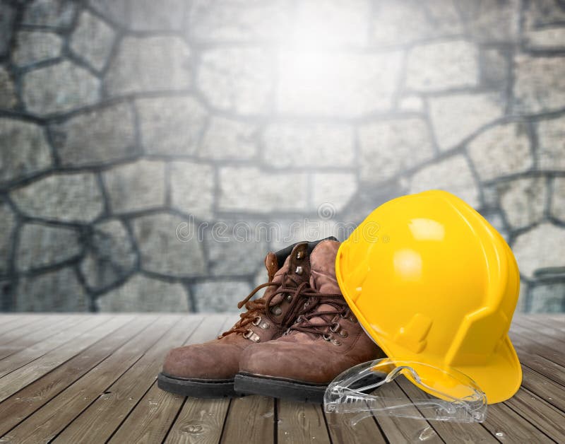 Yellow Working Hard Hat and Work Boots on Wall Stock Photo - Image of ...