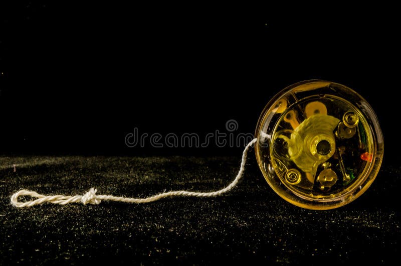 A Yellow Yo-yo is Tied To a String Stock Image - Image of macro, modern ...