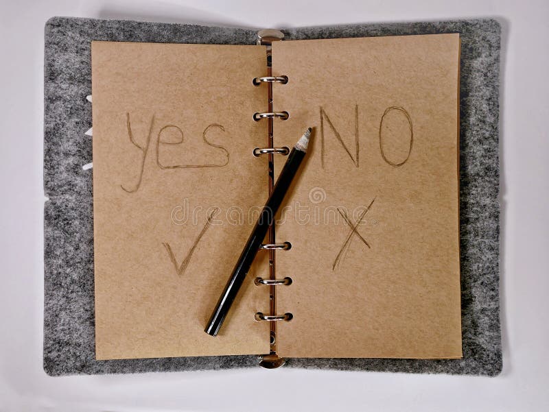 Yes and No Written with Pencil in a Notebook with Craft Paper Pages ...