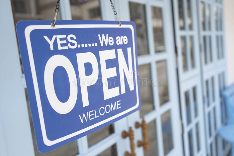 Yes we`re Open Sign on the Blue Doors in Store. Welcome Sign at the ...