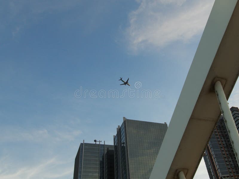 Plane between Apartment Buildings Stock Photo - Image of facade ...