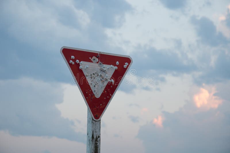 Yield Sign with Bullet Holes Stock Photo - Image of holes, post: 97918170
