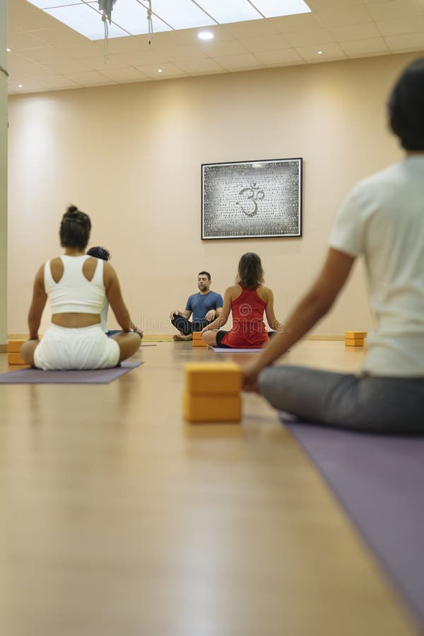 Yoga Teacher Teaching a Class in Sukhasana Pose Stock Image - Image of ...
