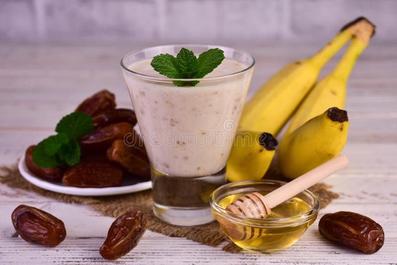 Yogurt with Date Fruit, Banana and Honey in a Glass with a Mint Leaf ...
