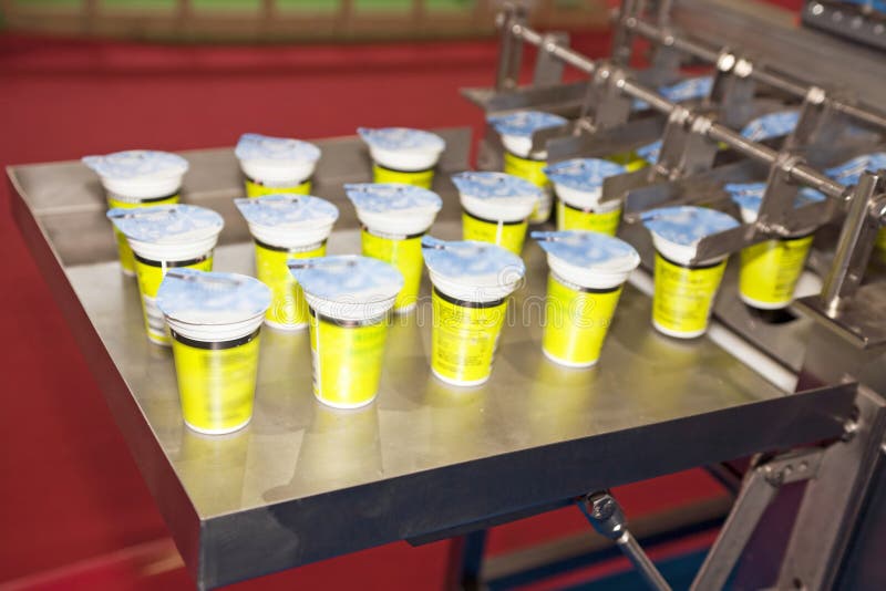 Yogurt Filling and Sealing Machin Stock Photo - Image of mechanical ...