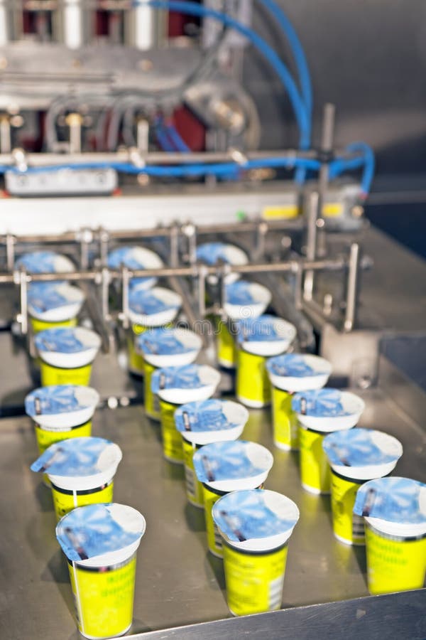 Yogurt Filling and Sealing Machine Stock Image - Image of piping ...