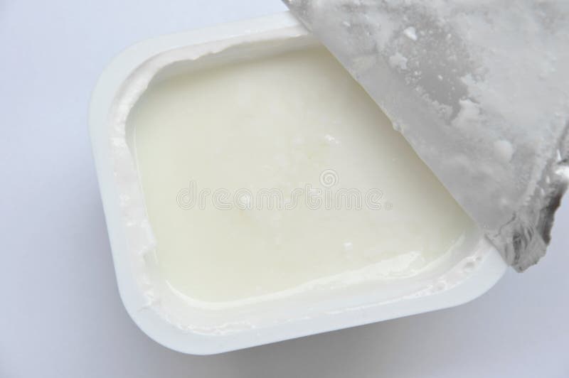 Yogurt Open from Plastic Cup on White Background Stock Photo - Image of ...
