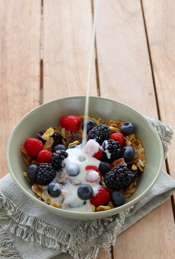 Yogurt pouring over muesli stock image. Image of sweet - 286261969