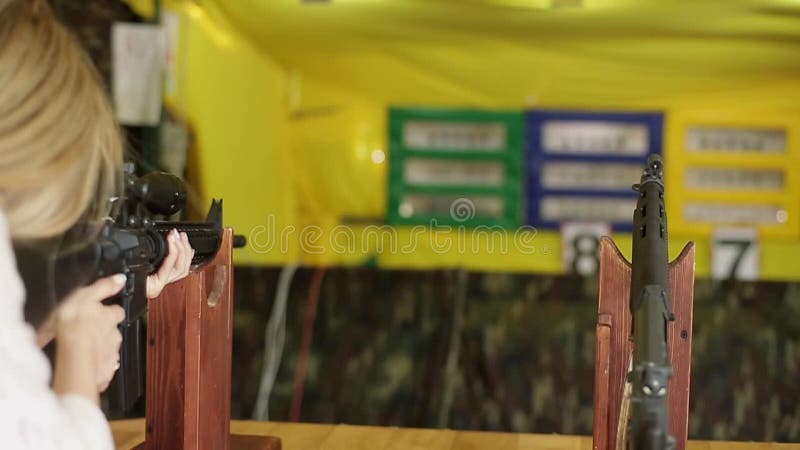 Yong Blonde Woman at Shooting Range Stock Video - Video of slowmotion ...